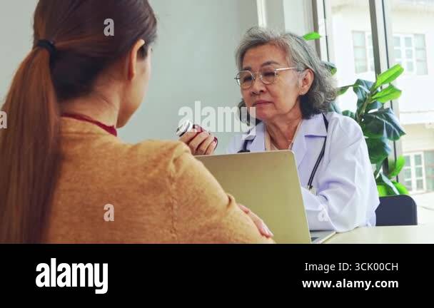 Senior female doctor provides treatment and diagnosis to female ...