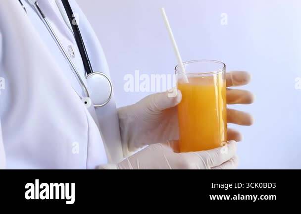 Close-up of a doctor holding a glass of soluble vitamins. Effervescent ...