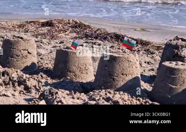 Sand castles with small Bulgarian flags. Sand figures on the beach near ...