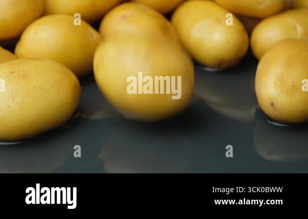 Slow motion of whole potatoes falling into water, splashing water Stock ...