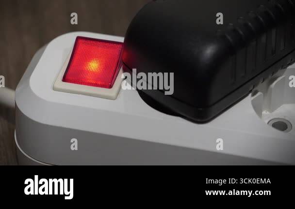 Black power adapter is take out the electric portable socket with red ...