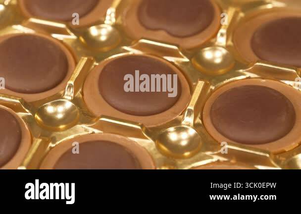 Delicious chocolate round shaped candies in open packaging Stock Video ...