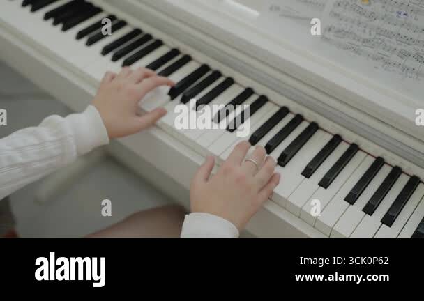 Teenage girl practicing piano at home. Study and learning development ...