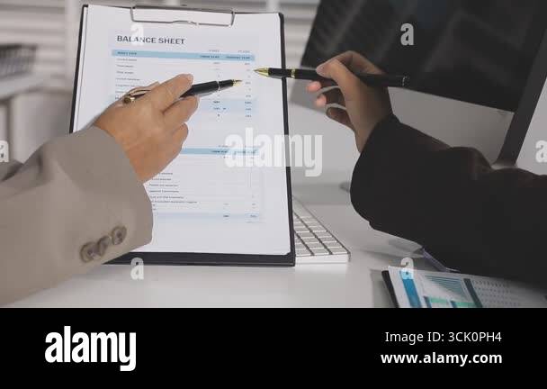 close up businessman hand using digital tablet and writing on paper in ...