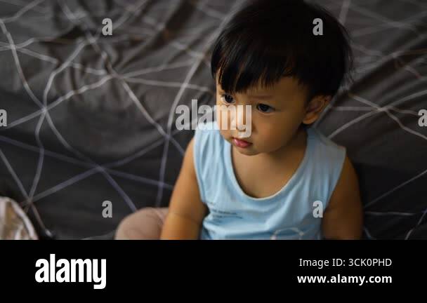 Happy Toddler Watching Cartoon, A joyful toddler giggles while watching ...