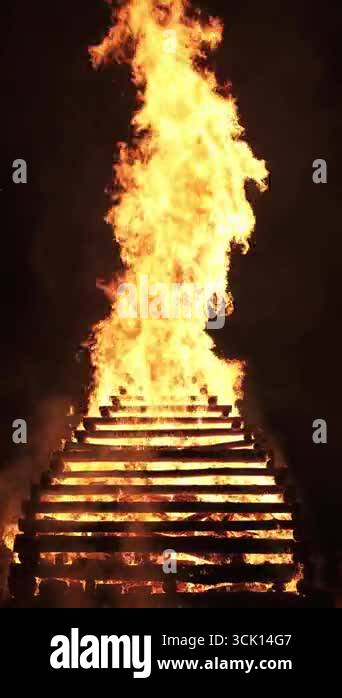 Huge bonfire with tall flames burning a wooden pile at night. Summer ...