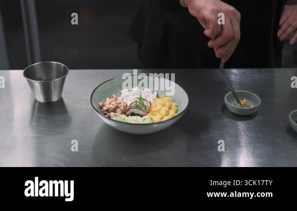 Cooking process. Serving meal. Chef hands adding dried ingredients dish ...