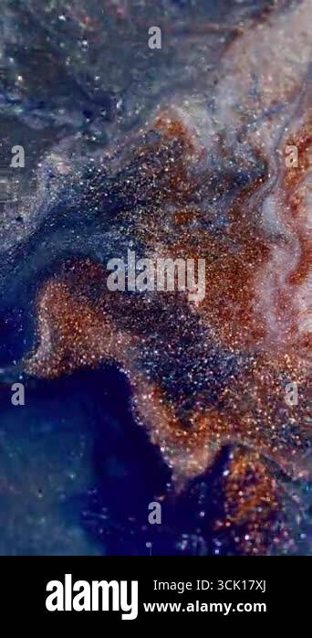Vertical video. Glitter flow. Colorful fluid. Shiny liquid dust spill mix surface. Defocused ...