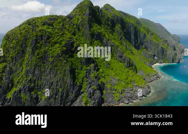 Rocky coastlines and towering hills in Tapiutan Island. Transparent ...