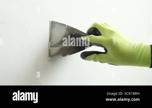Worker Applying Wall Putty With A Spatula While Smoothing The Wall ...