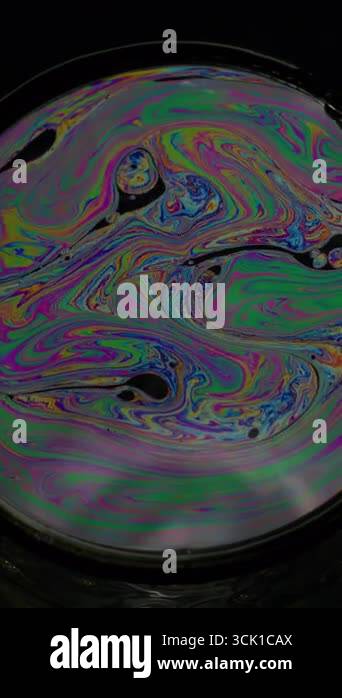 Vertical video. Holographic bubble. Gasoline texture. Rainbow liquid ...