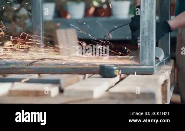 Grinding of welded joints. A man is processing a metal product with an ...