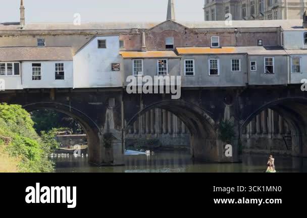 Historic riverside bridge in Bath, England, reflects European ...