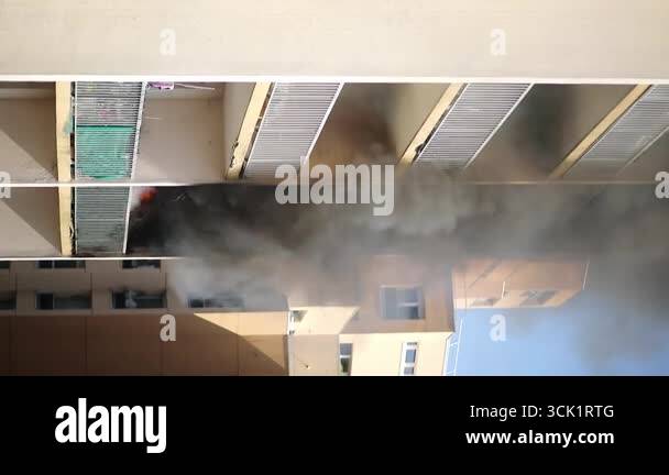 Residential building on fire, flames and smoke breaking out from the ...