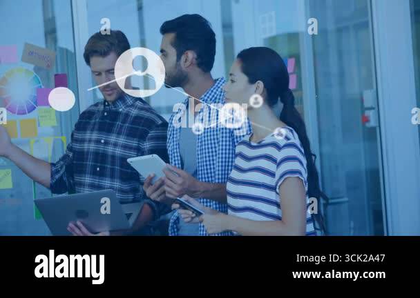 Business team pointing at notes and tapping devices, revealing network ...