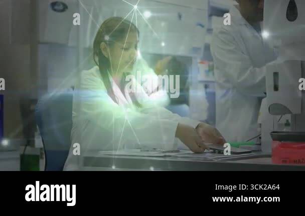 Female lab scientist sorting slides using tablet starting overlay while ...