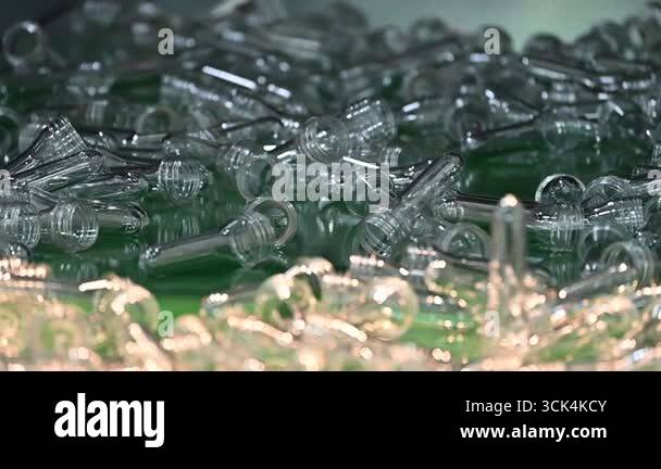 Slow motion scene the plastic bottle preform shape on the conveyor belt ...