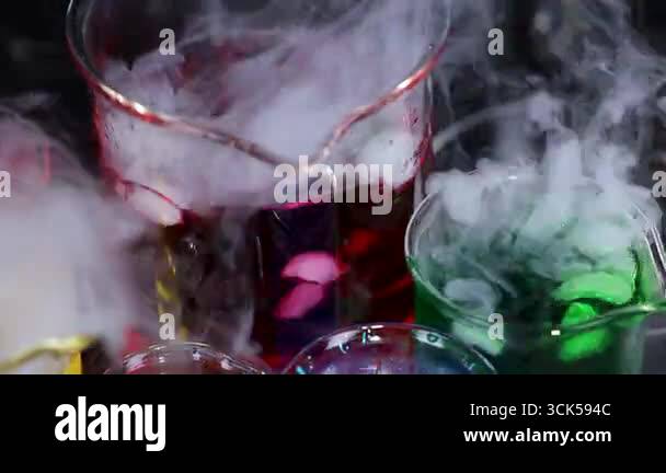 Beakers with dry ice create colorful smoke effects Stock Video Footage ...