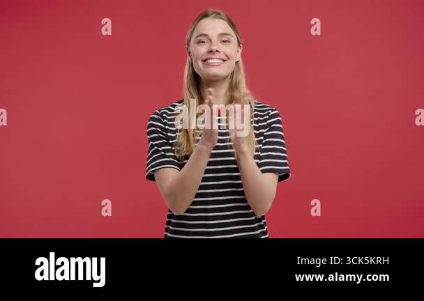 Confident charming model applauds with open smile and active body ...