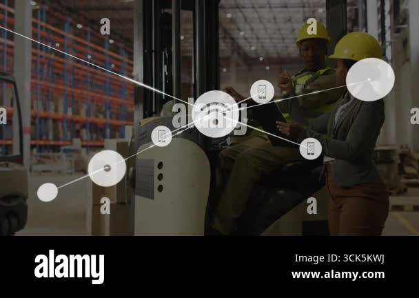 Operator and supervisor pointing tablet analyzing stock in warehouse ...