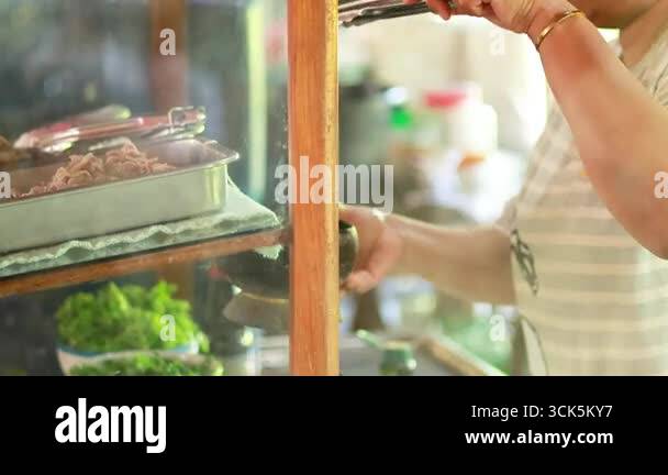 Vendor prepares pork noodles at Bangkok market Stock Video Footage - Alamy