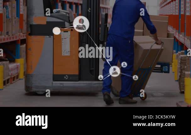 Worker pushing hand truck down aisle, organizing stock as data overlay ...