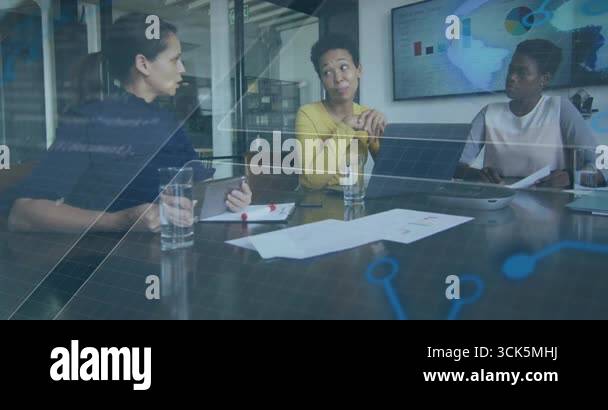 Yellow-cardigan presenter explaining business charts, team noting insights with graphics ...