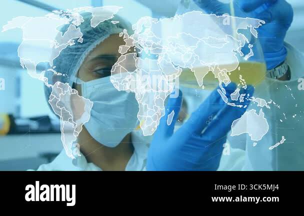 Female scientist raising flask to eye-level inspecting sample as world ...