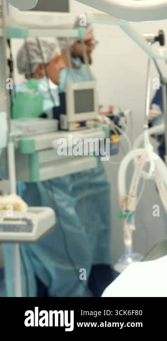 A focused middle-aged Caucasian surgeon, clad in a surgical cap and ...