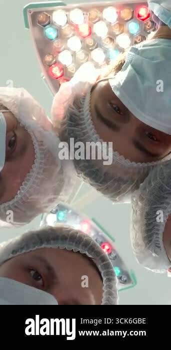 An attentive surgical team, featuring four male surgeons and one female ...