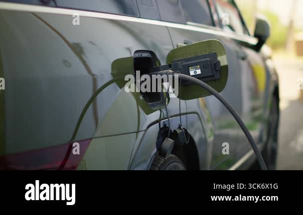 Close up shot of electric SUV automobile charging at modern station ...