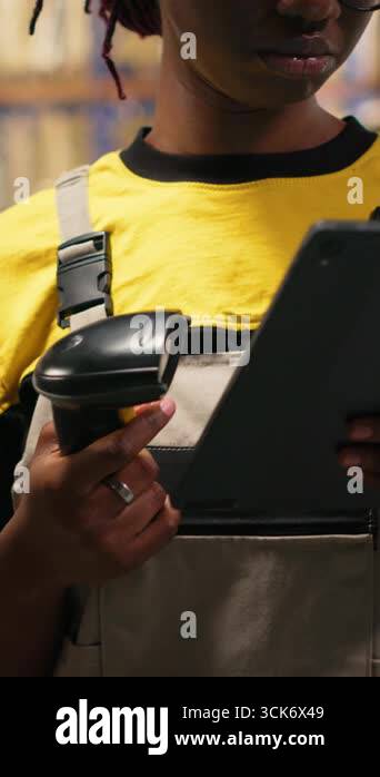 Vertical Video Employee using barcode scanner on cardboard boxes in ...