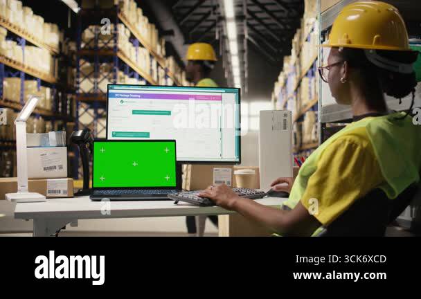 Female warehouse clerk checking awb labels next to chroma key on screen, working in depot with ...