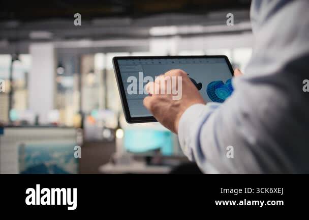 Close up of engineer using CAD app on tablet to make wind turbine ...