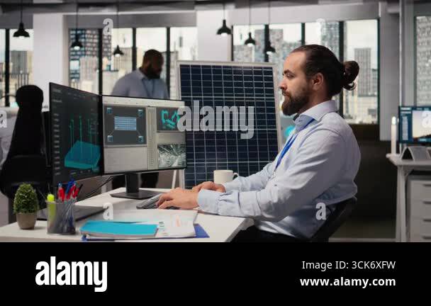 Portrait of happy sustainable energy researcher using simulation software to upgrade solar ...