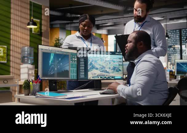 Team of engineers brainstorming how to optimize electric grid and wind farm layout to produce ...