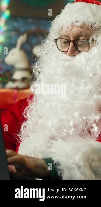 Vertical video Person dressed as Santa Claus wearing fake beard, red ...
