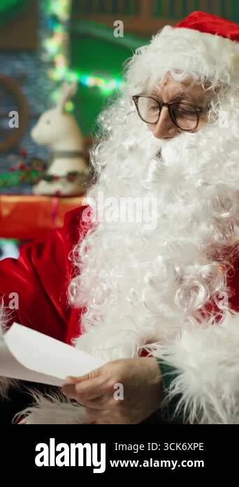 Vertical video Senescent Santa Claus with bad eyesight struggling to ...