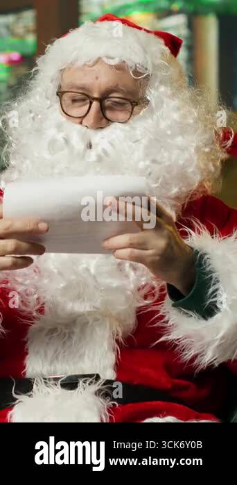 Vertical video Santa Claus getting gift box falling from sky while ...