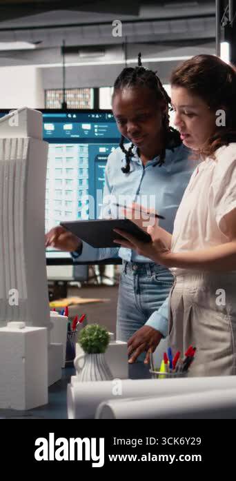 Vertical Video Diverse female contractors sharing structural layout ...