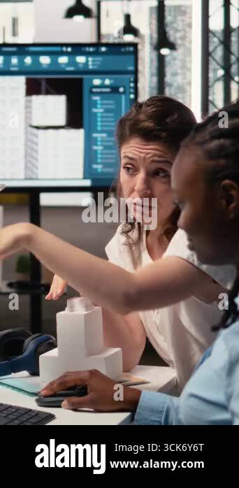 Vertical Video Two developers reviewing blueprints for real estate ...