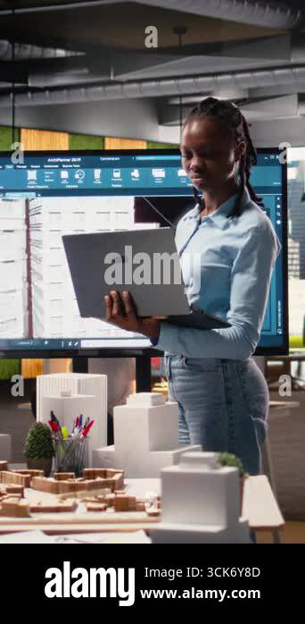 Vertical Video Black female developer reviewing zoning regulations with ...