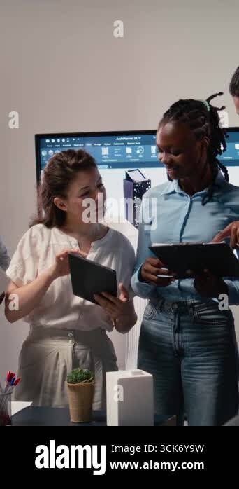Vertical Video Diverse team of real estate developers using 3D models ...