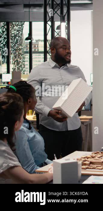 Vertical Video Property engineers team study architectural blueprints ...