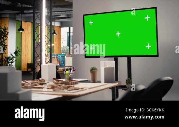 Empty real estate office with a huge isolated green screen TV in innovation hub, prepared for ...