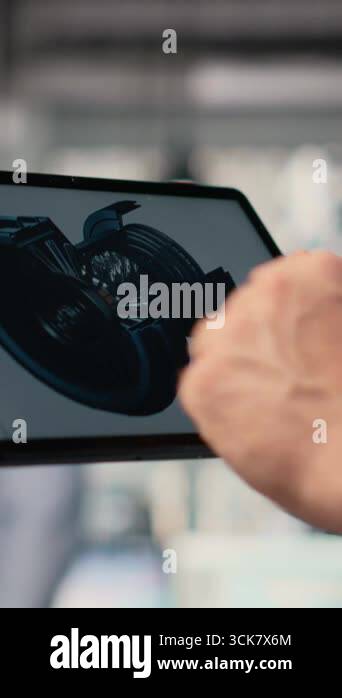 Close up of engineer using CAD app on tablet to make wind turbine ...