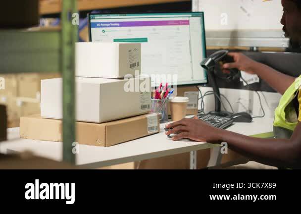 African american clerk uses barcode scanner to register shipment ...