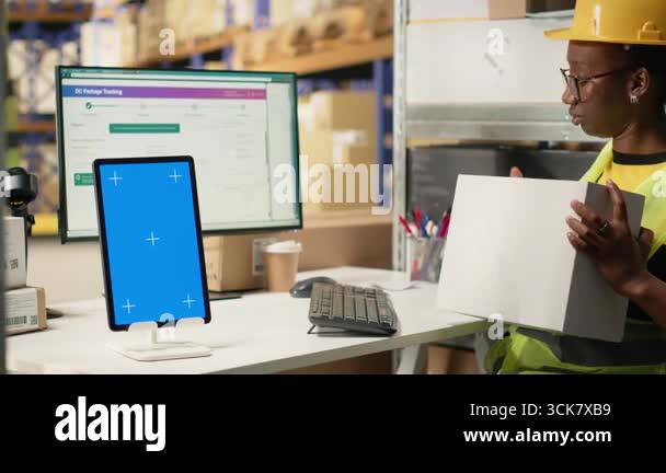 Male warehouse clerk printing barcode labels next to chroma key ...