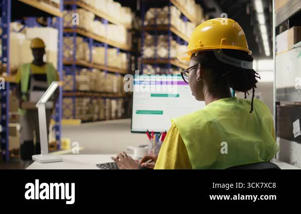 African american female in hi vis vest scanning barcodes for parcel ...