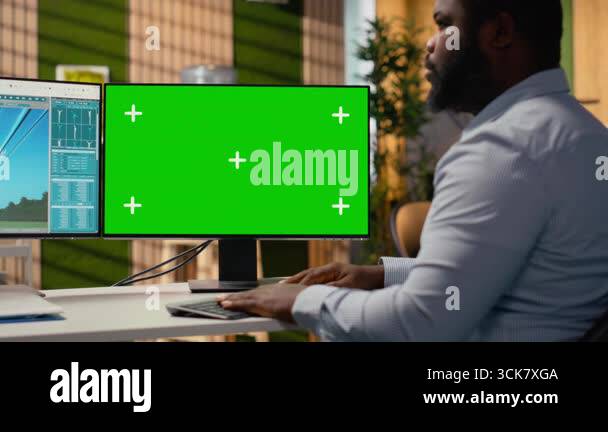 Technician works on power line tower CAD design on green screen PC in ...